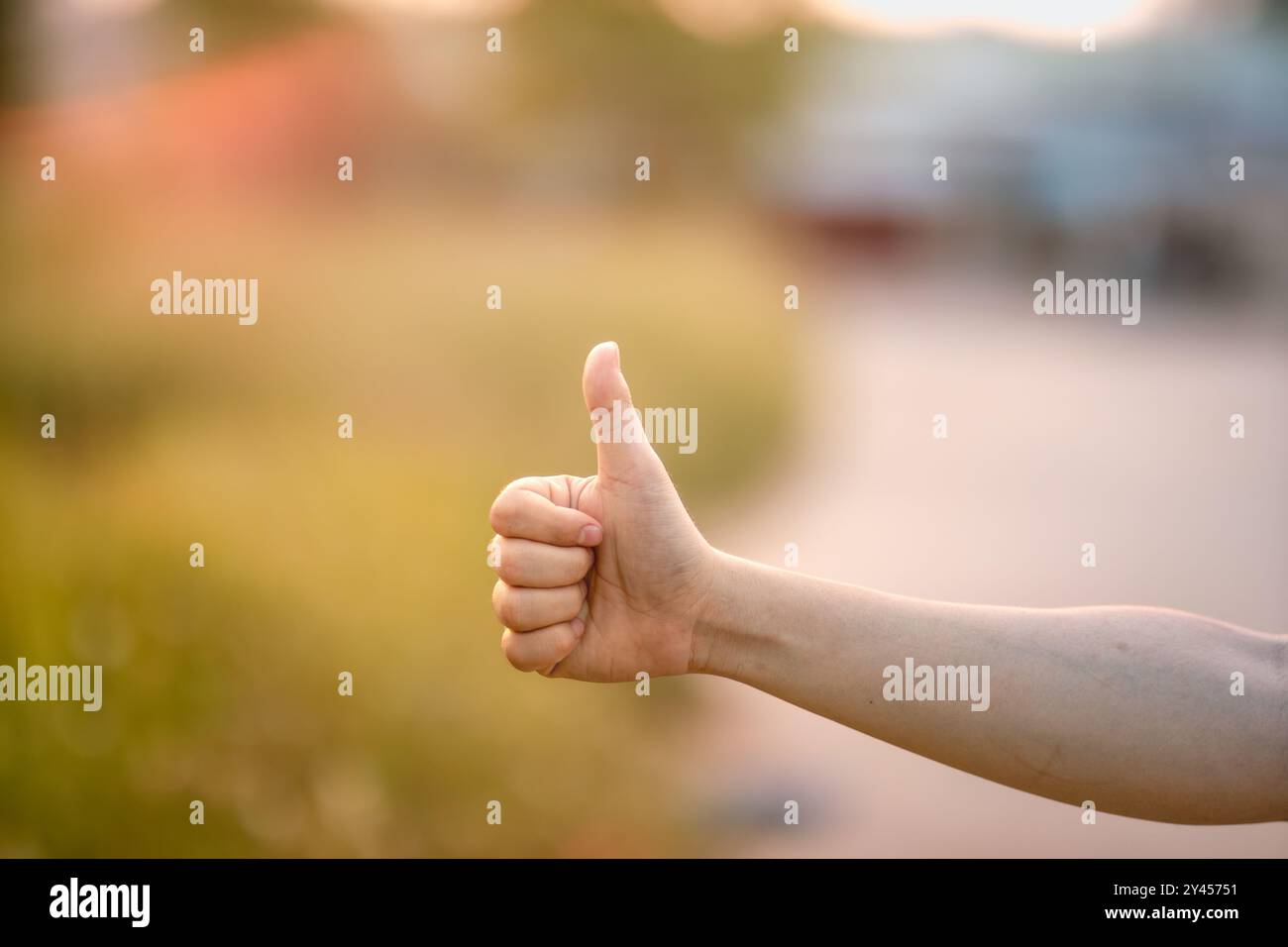 a man's thumb is raised upwards. The hand gesture shows as if you are ...