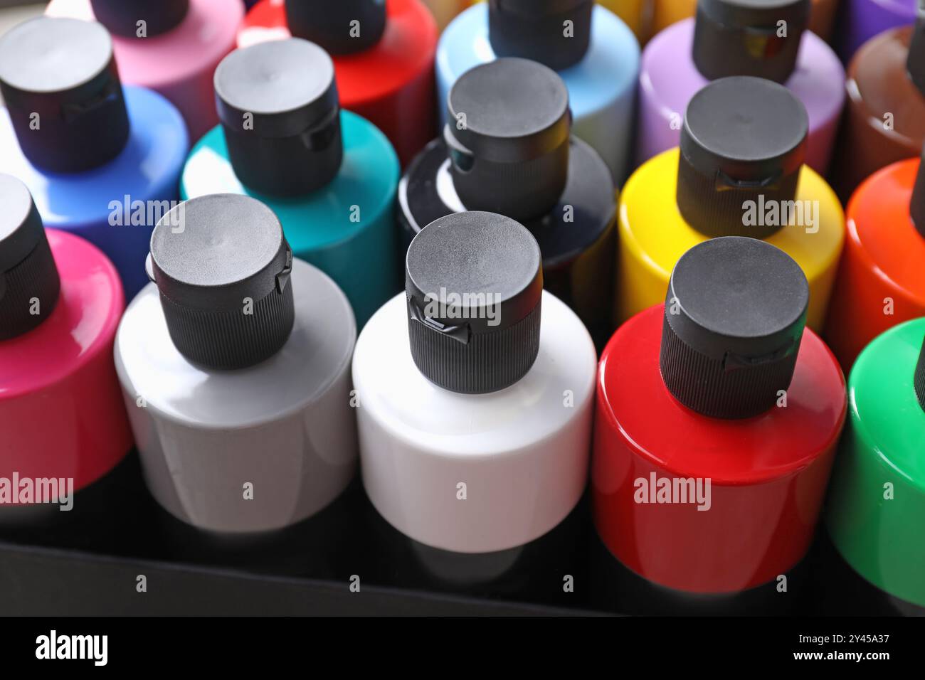 Acrylic paints of different colors in bottles, closeup Stock Photo - Alamy