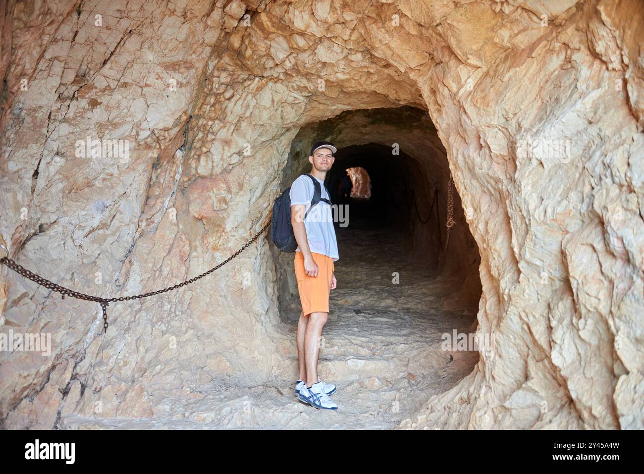 Daring Young Adventurer Poised at Threshold of Enigmatic Cave System ...
