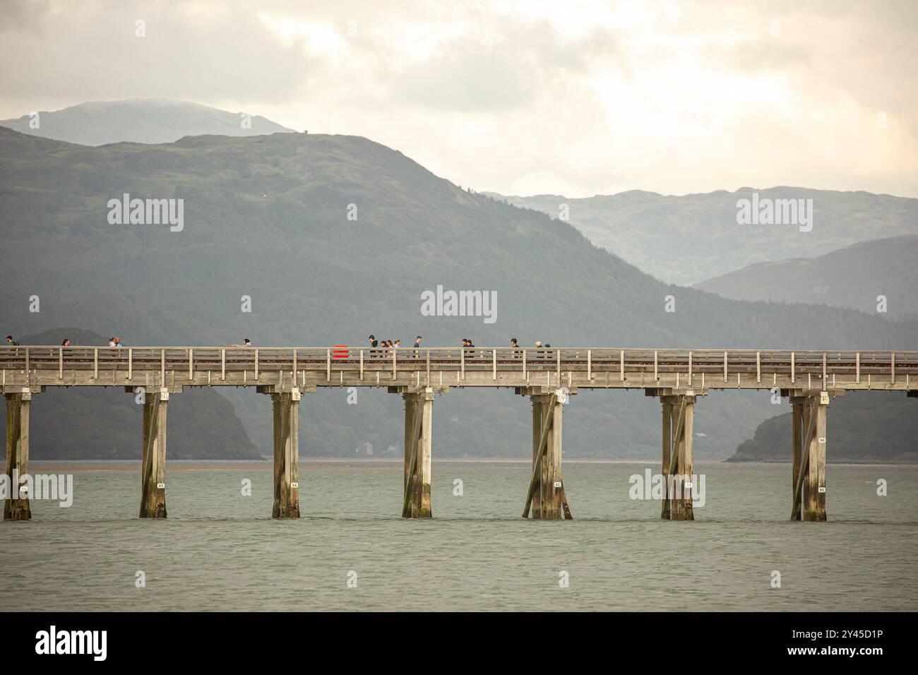 People walking over Barmouth Bridge in the Welsh county of Gwynedd, the ...