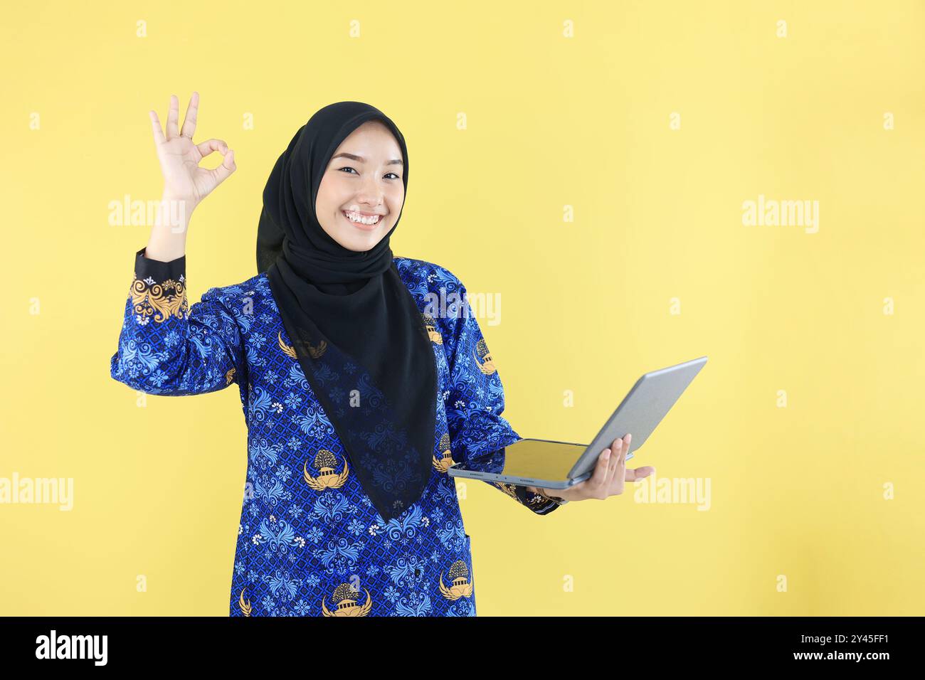 Female Indonesian ASN PNS Holding Laptop Tablet Computer with OK ...