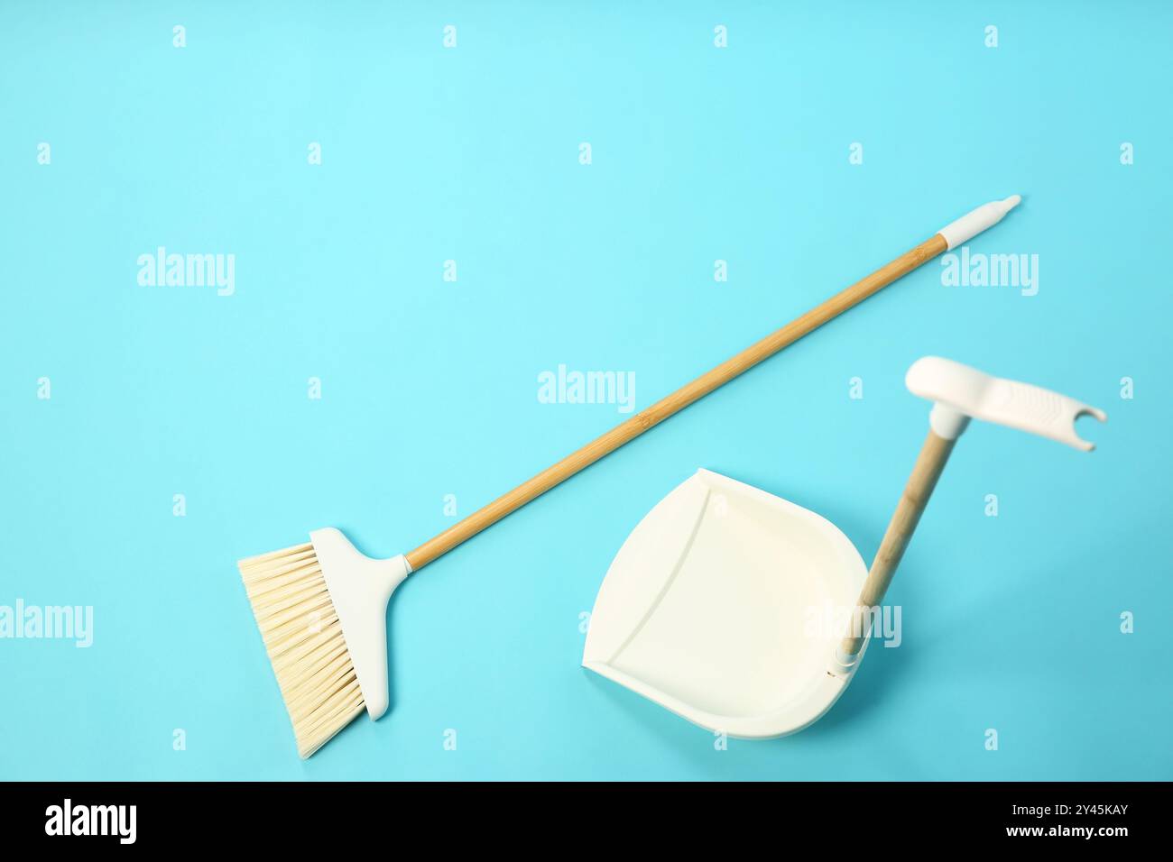 Cleaning broom and dustpan on light blue background, flat lay Stock ...