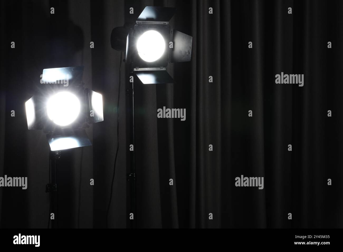 Professional spotlights against dark curtain. Space for text Stock ...