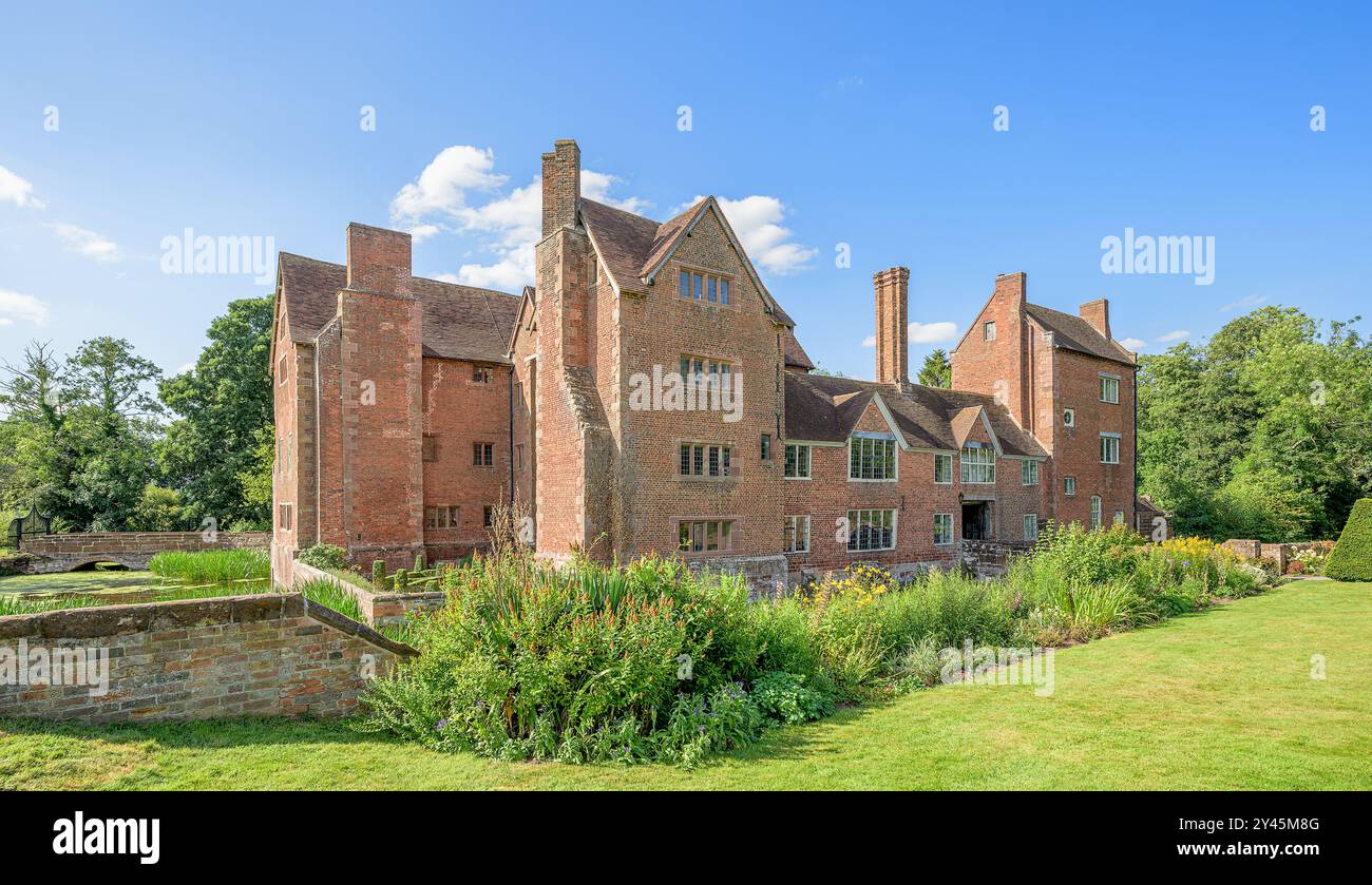 Harrington hall, a historic brick mansion with lush garden on sunny day ...
