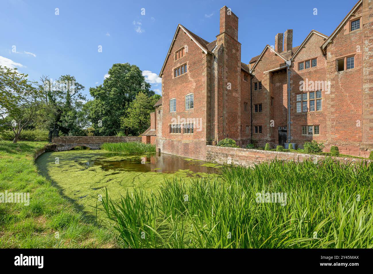 Harrington hall, a historic brick mansion with lush garden on sunny day ...