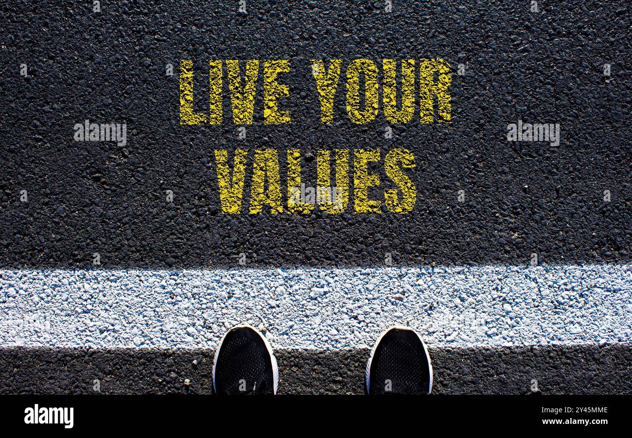 Live your values message written on asphalt road. Conceptual live your ...