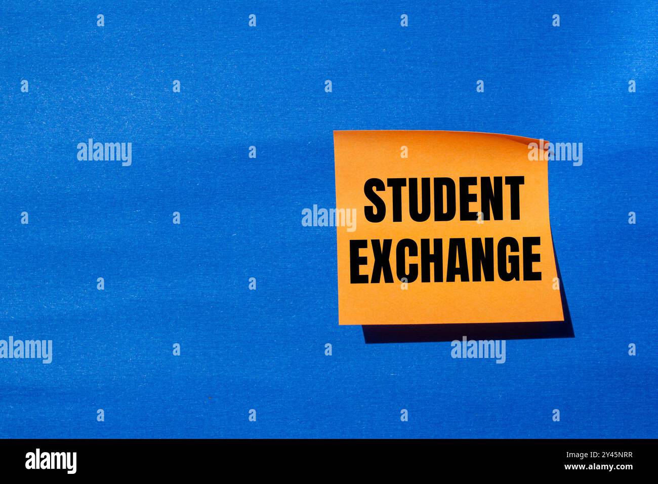 Student exchange message written on orange paper with blue background ...