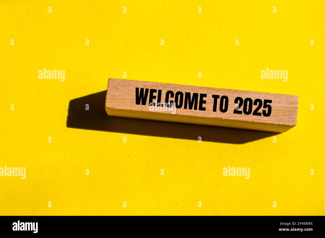 Welcome to 2025 message written on wooden block with yellow background ...