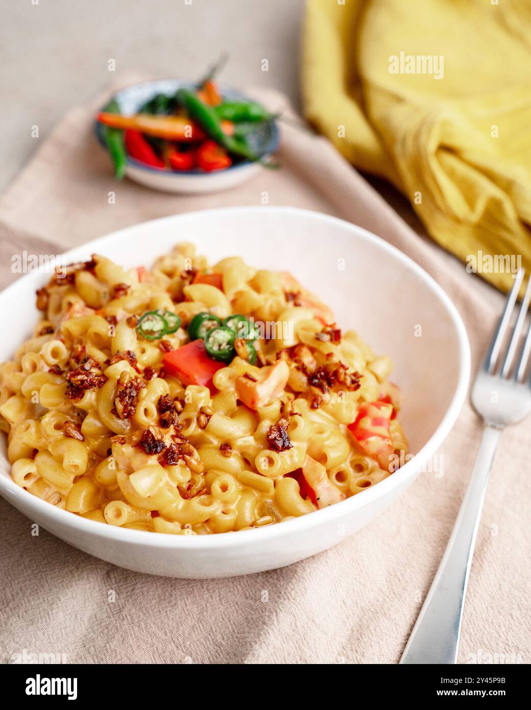 Creamy peri-peri pasta served with chilli crunch and fresh chilli's ...