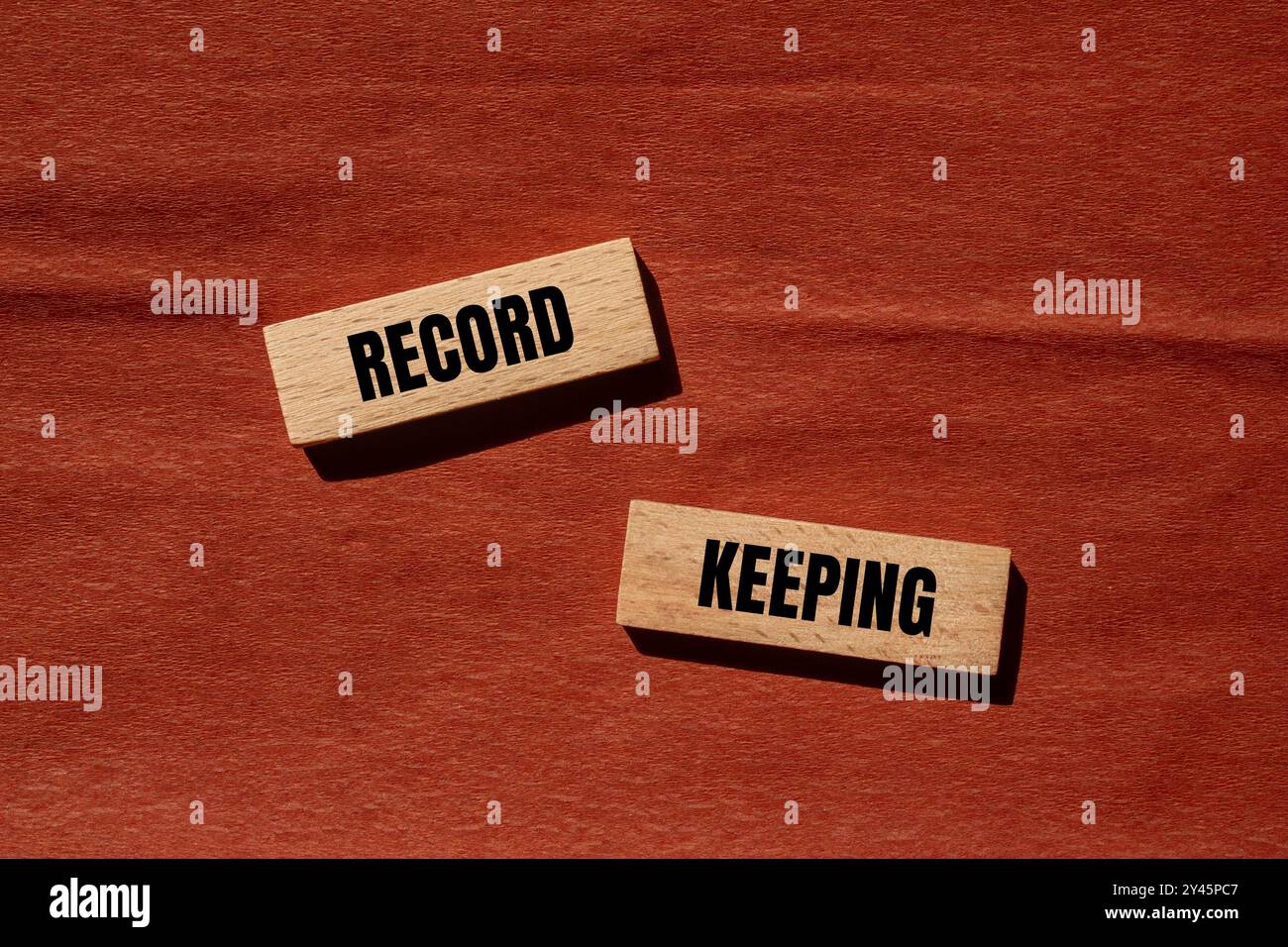 Record keeping message written on wooden blocks with brown background ...