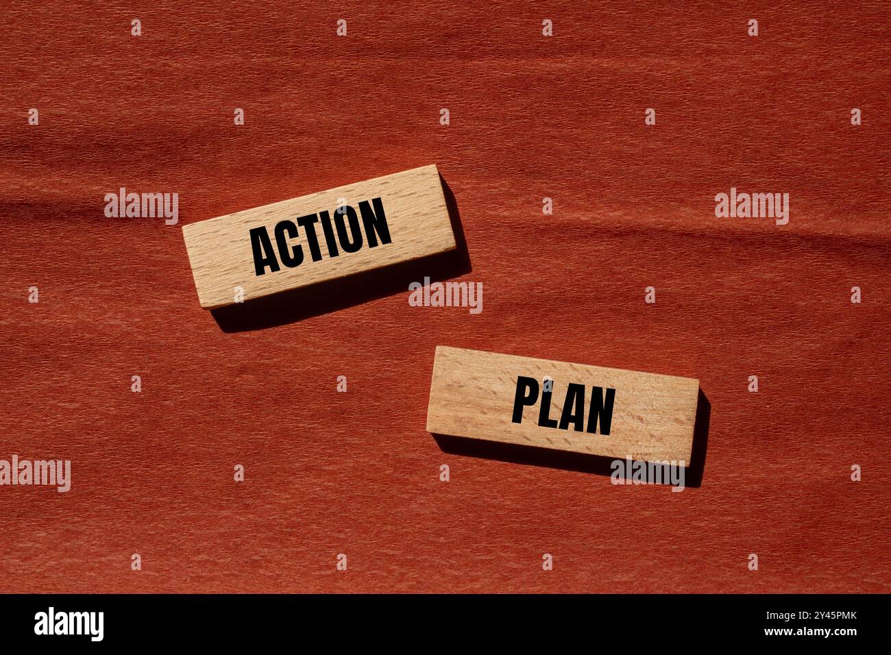 Action plan message written on wooden blocks with brown background ...