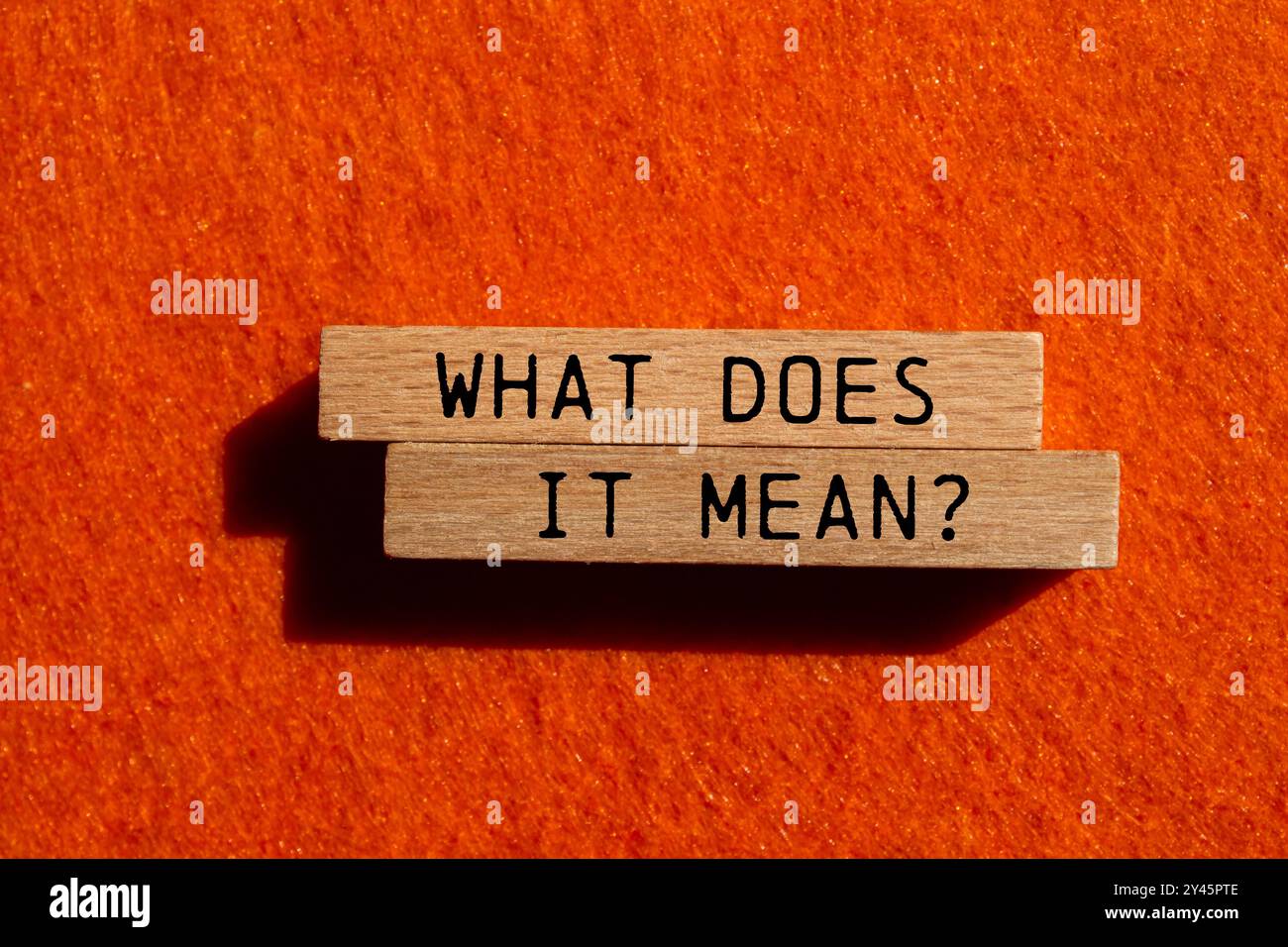 What does it mean question written on wooden blocks on orange felt ...