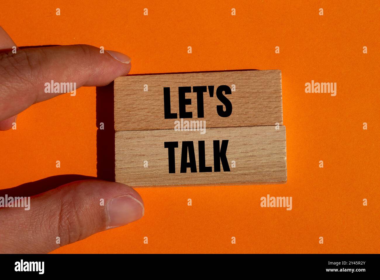 Let's talk message written on wooden blocks on orange background ...
