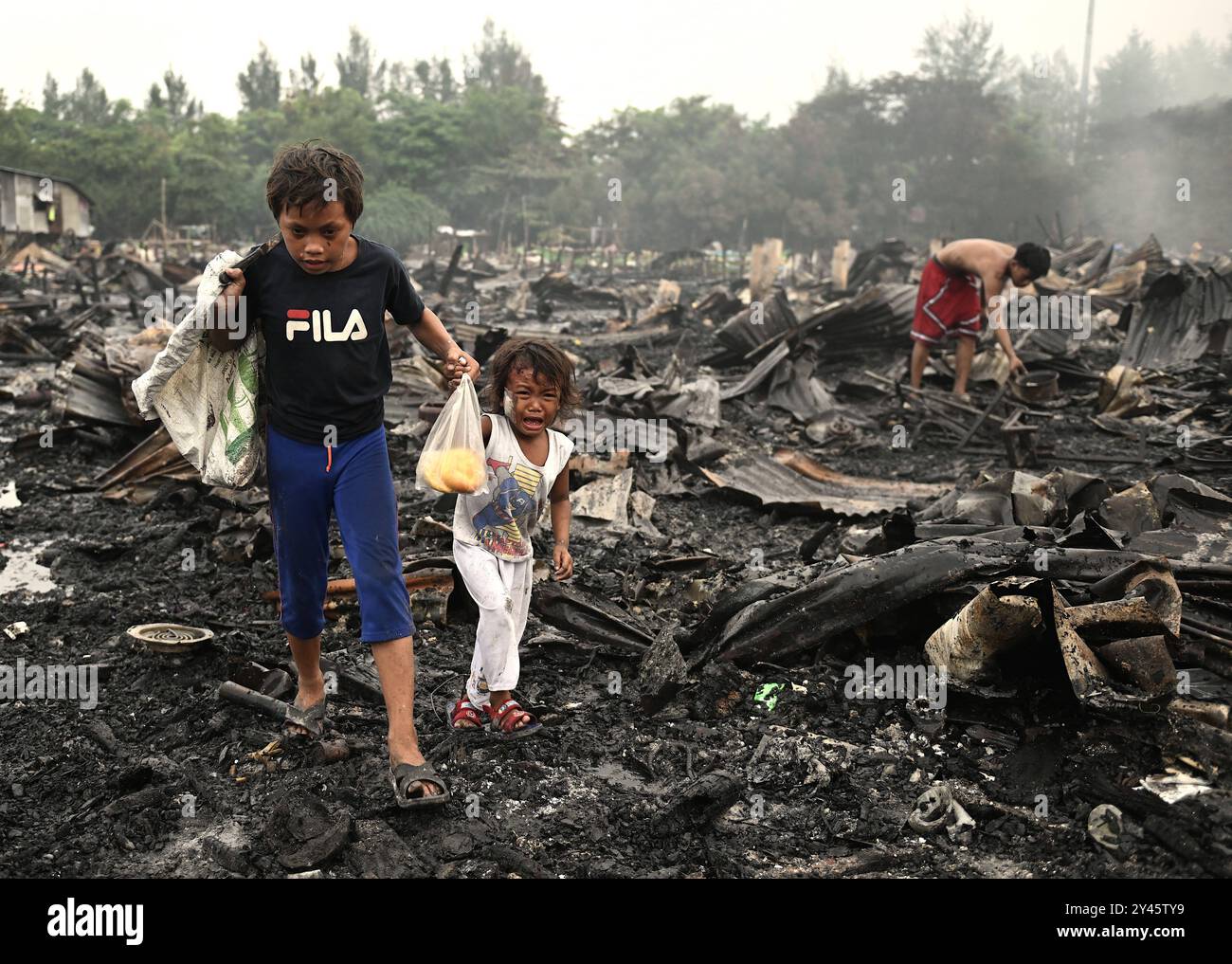 Aftermath of a fire in the Bacoor, Cavite, south of Manila Siblings ...