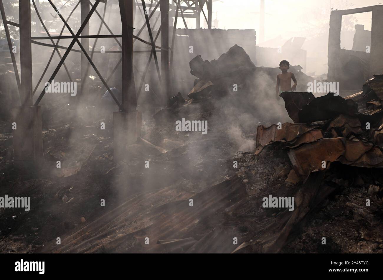 Aftermath of a fire in the Bacoor, Cavite, south of Manila A boy stands ...