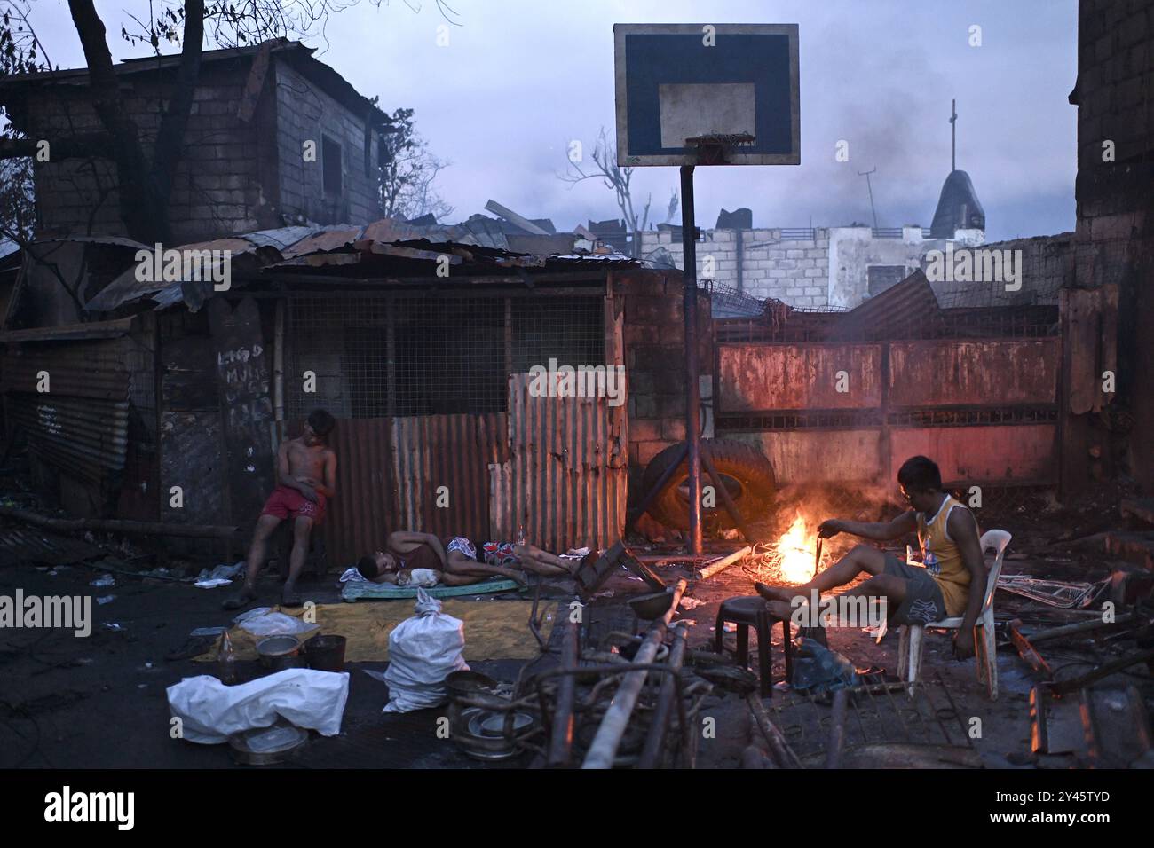 Aftermath of a fire in the Bacoor, Cavite, south of Manila Men sleep ...