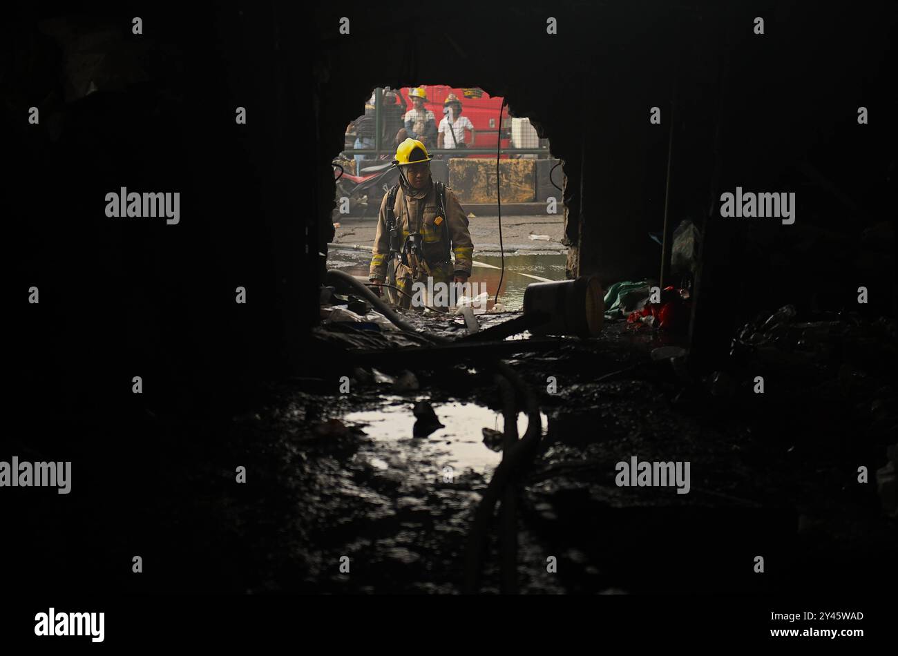 Fire in informal settlement in Manila, Philippines A fireman looks at a ...