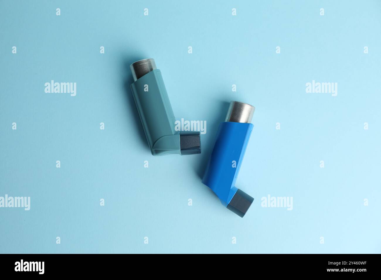 Asthma inhalers on light blue background, top view Stock Photo - Alamy