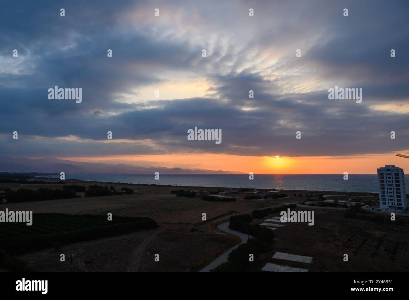 Majestic sunset colors over mountain with sea and city view Stock Photo ...