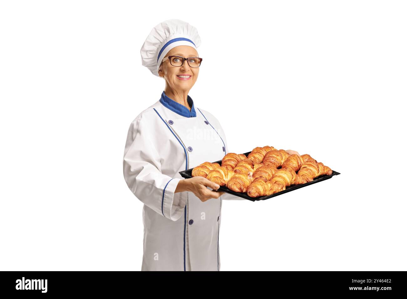 Female chef holding a tray with croissants isolated on white background ...