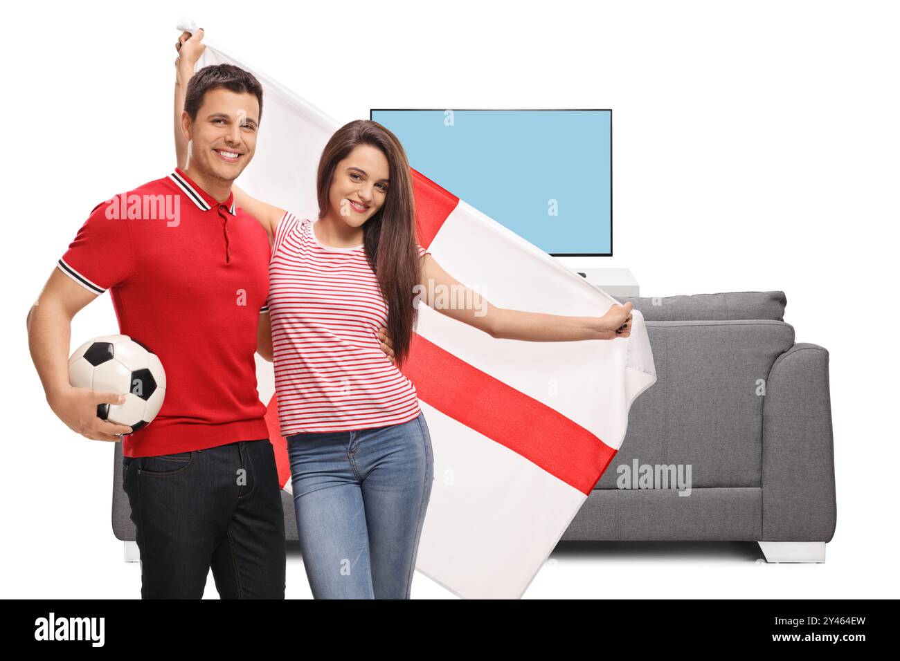 Young couple football fans with an English flag cheering in front of tv ...