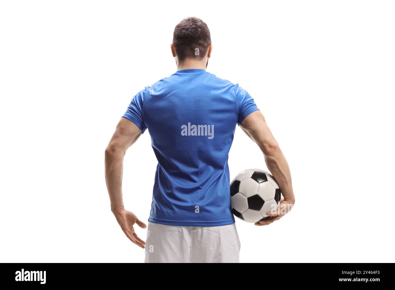 Rear view shot of a soccer player with a ball under arm isolated on ...