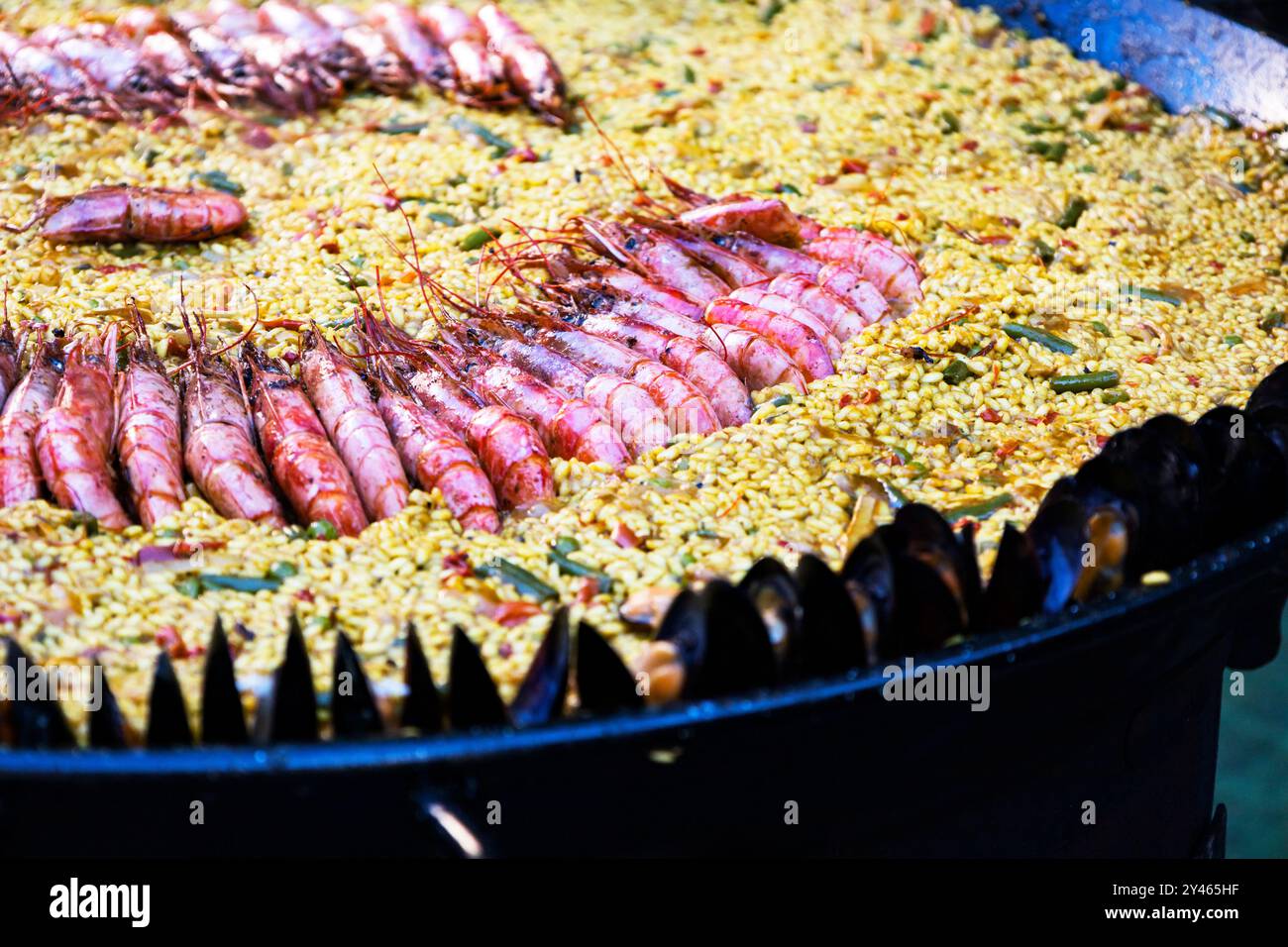 A large, sizzling pan filled to the brim with delicious rice and juicy ...