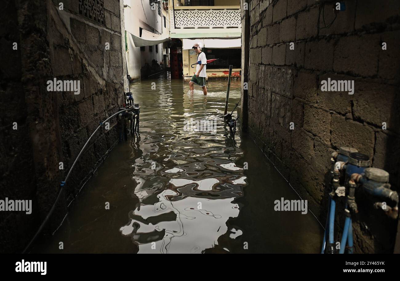 Flooding caused by typhoon Yagi in Philippines A man wades through a ...