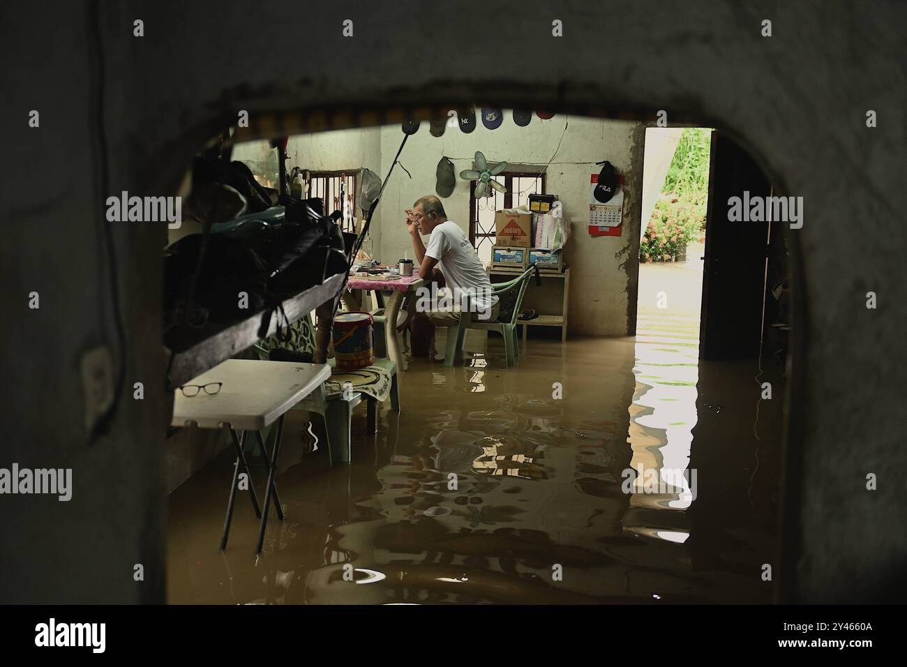 Philippines Typhoon Yagi A man sits on his table inside his flooded ...