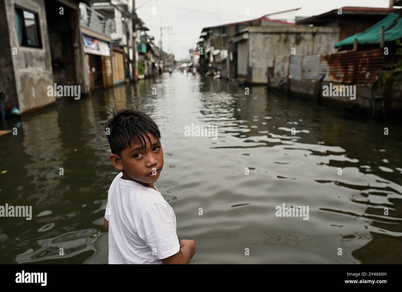 Flooding caused by typhoon Yagi in Philippines A boy wades through a ...