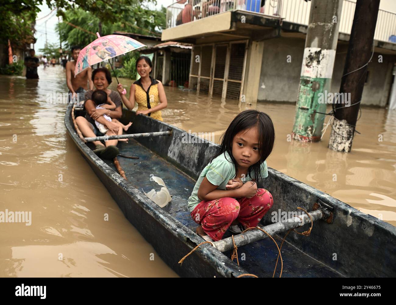 Flooding caused by typhoon Yagi in Philippines People ride on a wooden ...