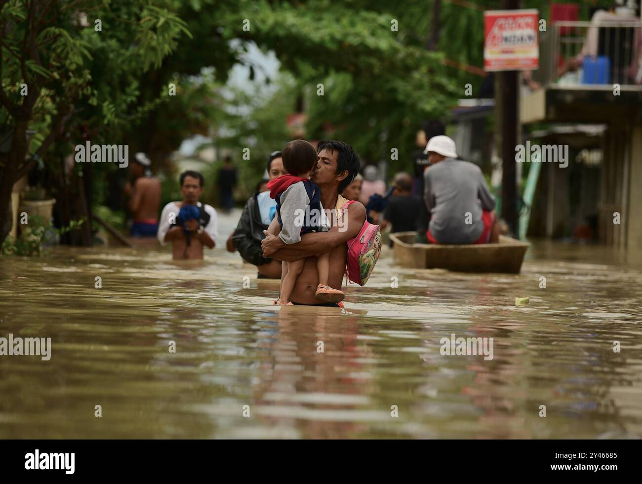 Flooding caused by typhoon Yagi in Philippines A father kisses her baby ...