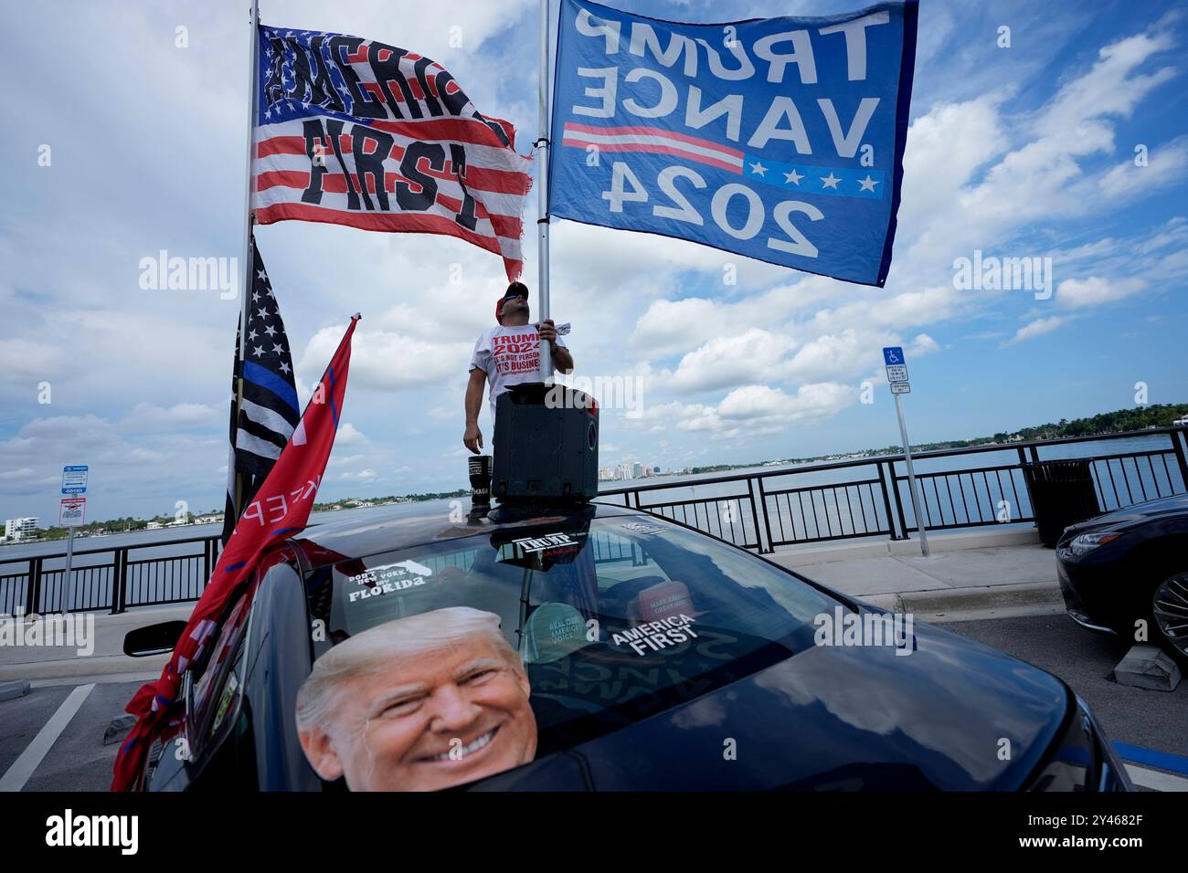 CORRECTS SPELLING OF JESTIN NEVAREZ - Jestin Nevarez, of Lake Worth, Fla., puts up flags on his ...