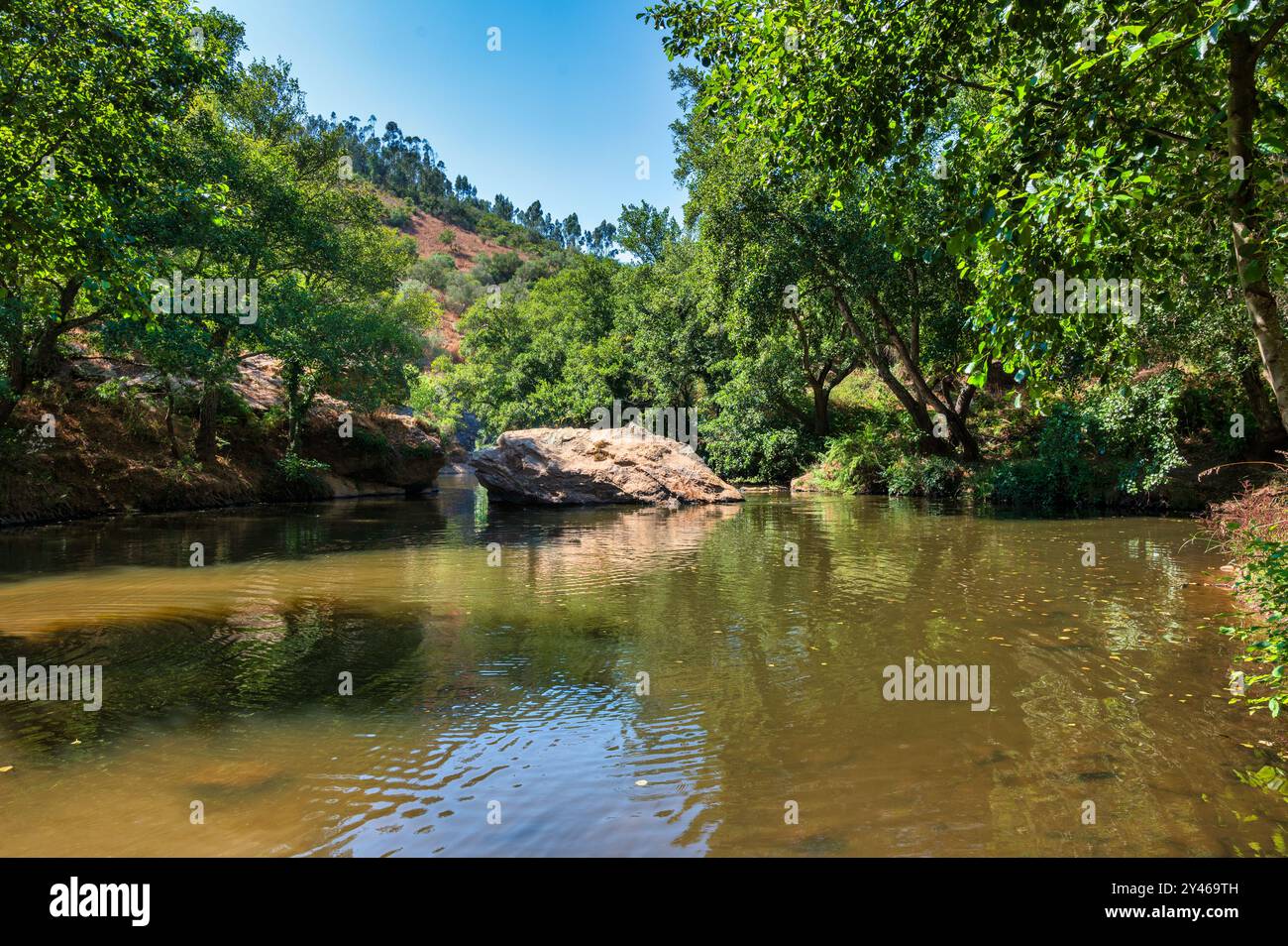 Narrow rocky gorge with still green water at Pego das Pias, a hidden ...