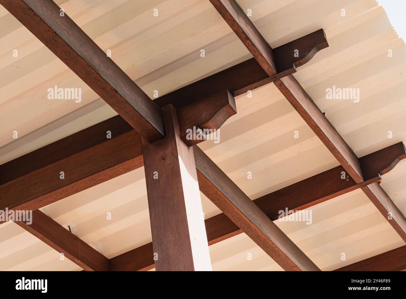 A close-up view of a wooden ceiling structure with exposed beams and a ...