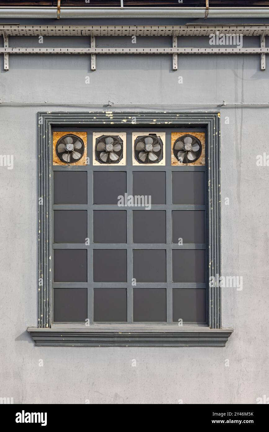 Built in Row of Fans at Black Glass Dark Tinted Window Industrial ...