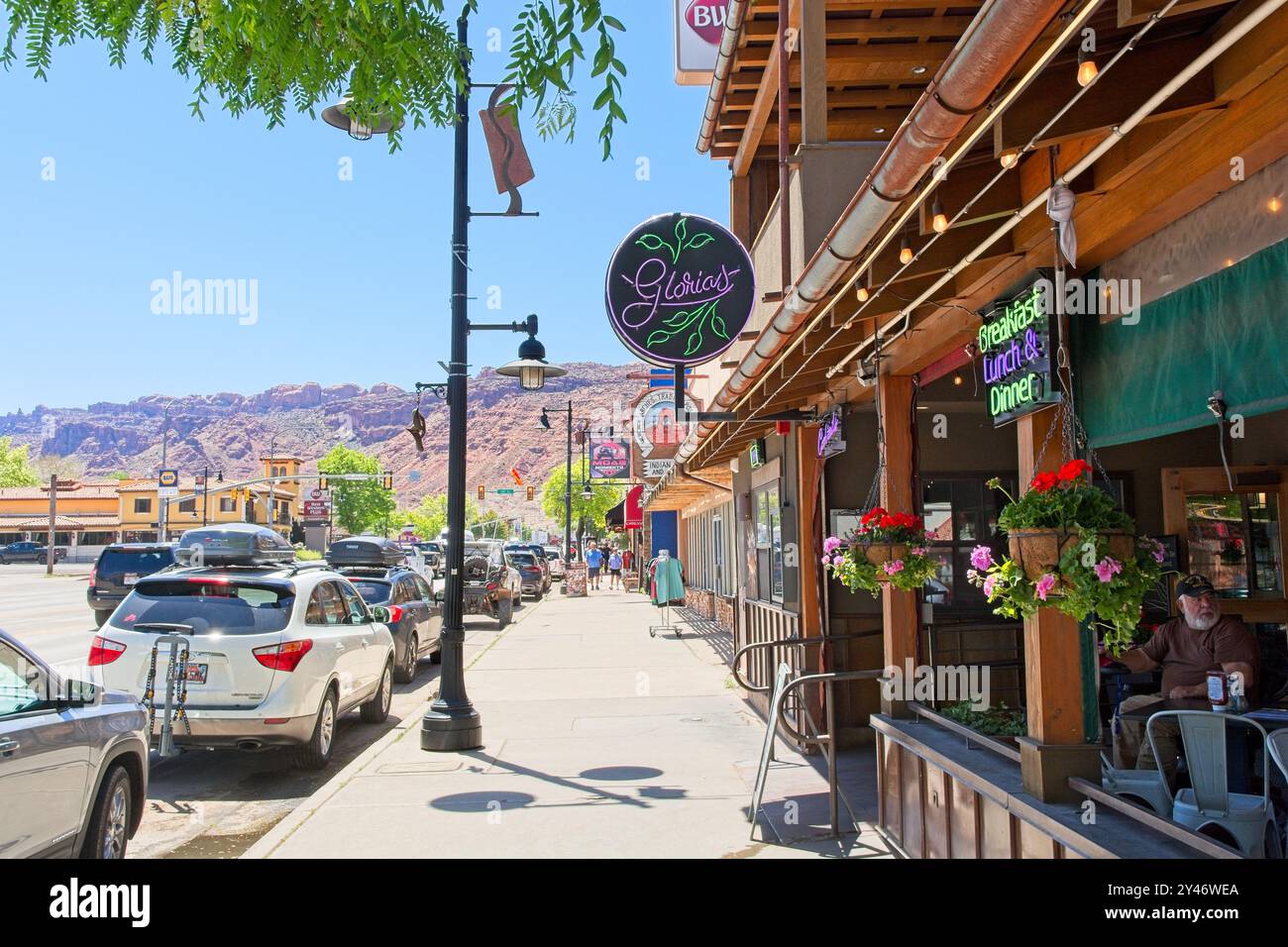Downtown commercial streetscape with red Moab rim cliffs background ...