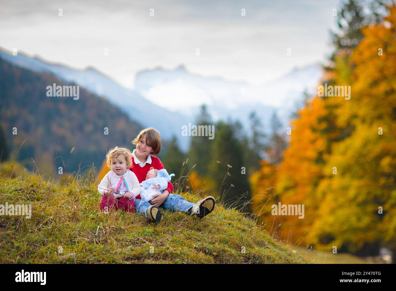 Family with kids hiking in the mountains. Young children hike in ...