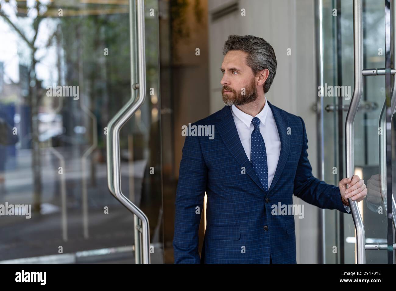 Mature entrepreneur at office door. American businessman suit leaving ...