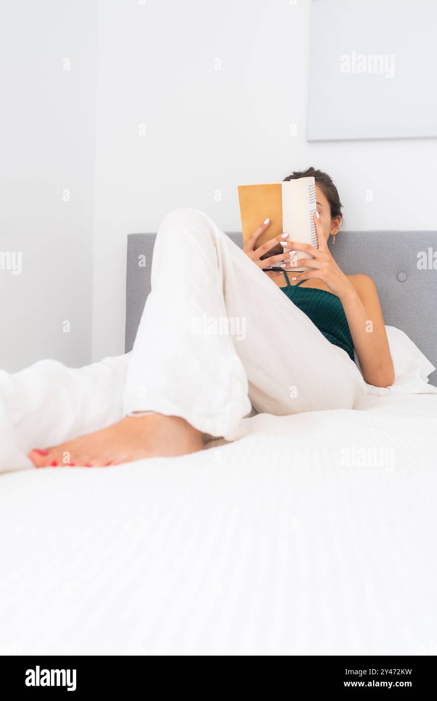 Portrait of a teenager reading a book with mock text. sitting on the ...