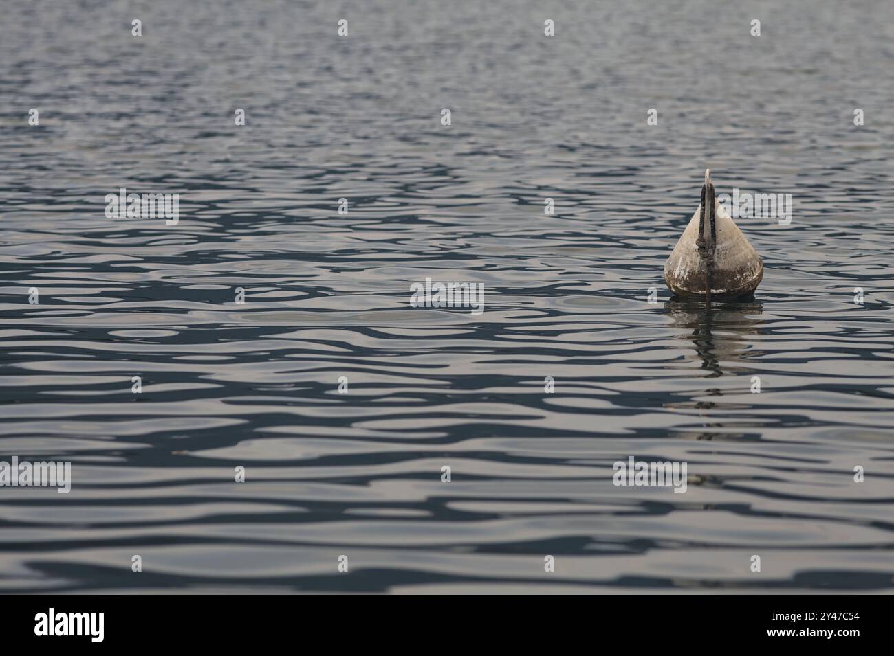 Bouy on a lake at sunset with its reflection casted in water Stock ...