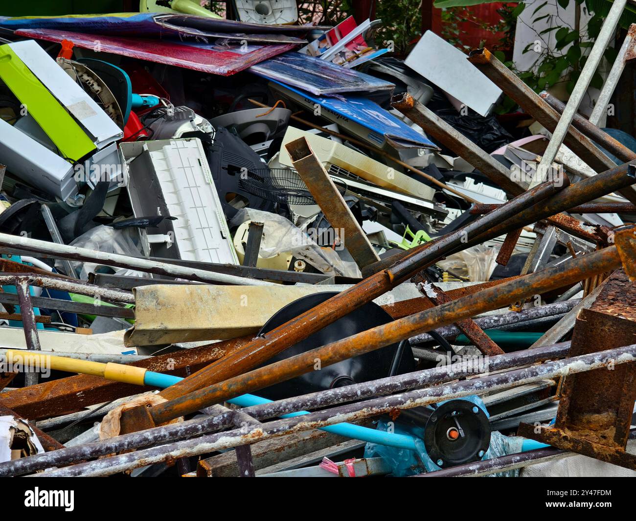 A pile of garbage with a bucket, rope, bottles, and other items at a ...