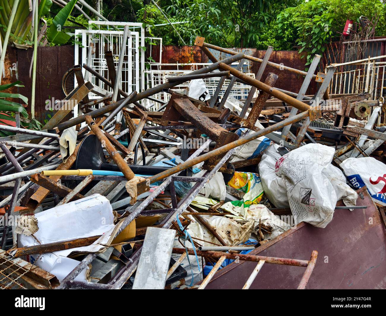 A pile of garbage with a bucket, rope, bottles, and other items at a ...