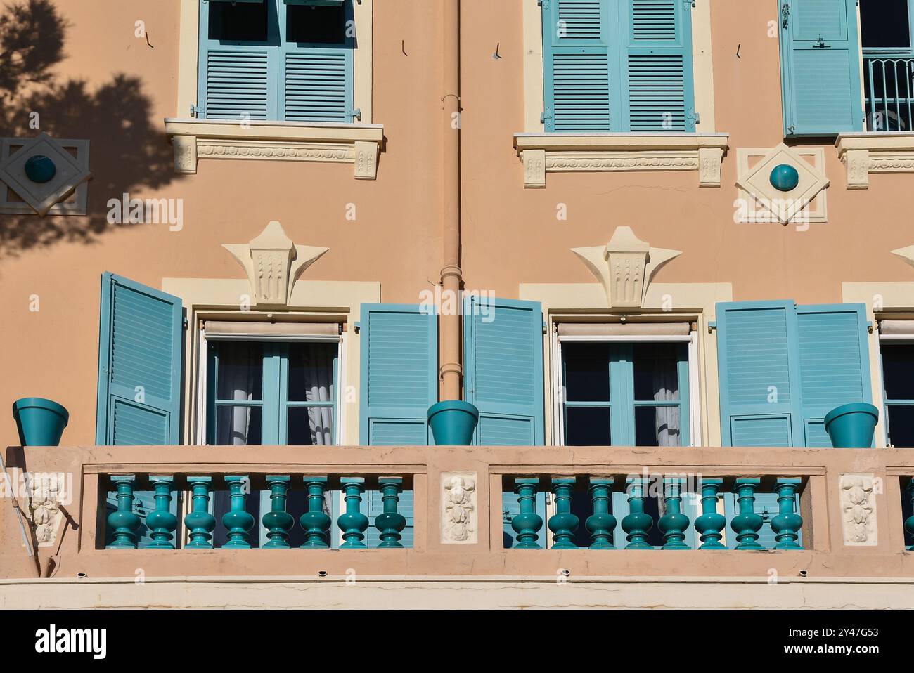 Detail of the facade of an elegant palace with blue shutters and a ...
