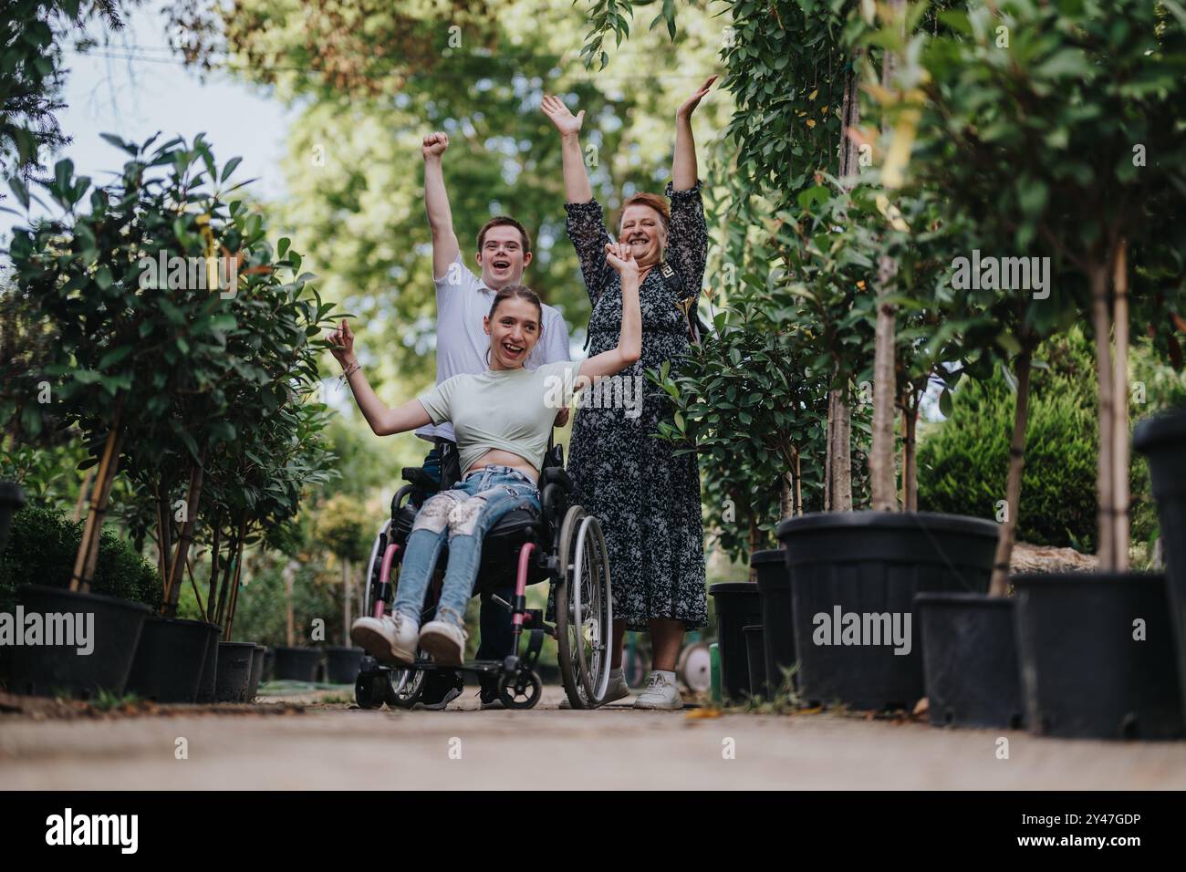 Joyful family outing with diverse abilities in garden setting Stock ...