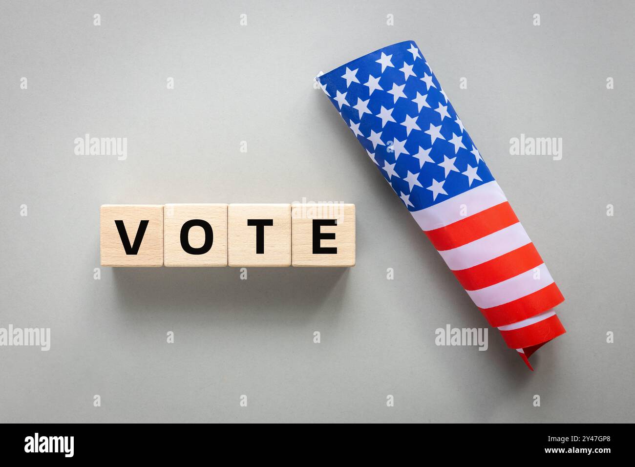 vote 2024, American flag and written word vote on wooden blocks. Gray ...