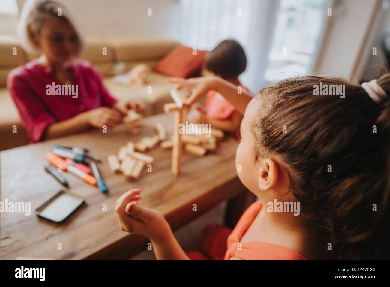 Family play time with building blocks and creative activities Stock ...
