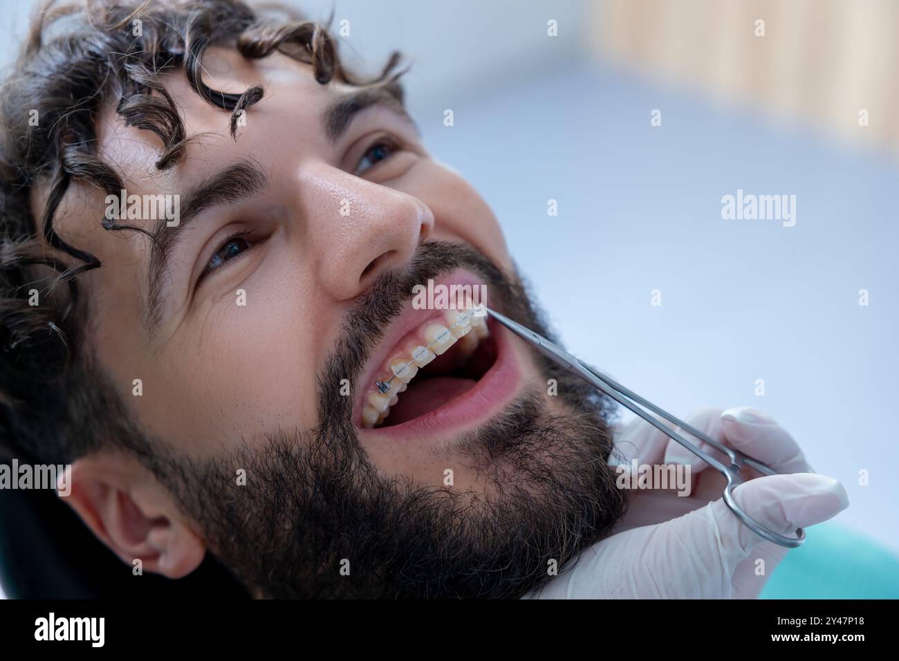Dentist performing examination with specialized tools during routine ...