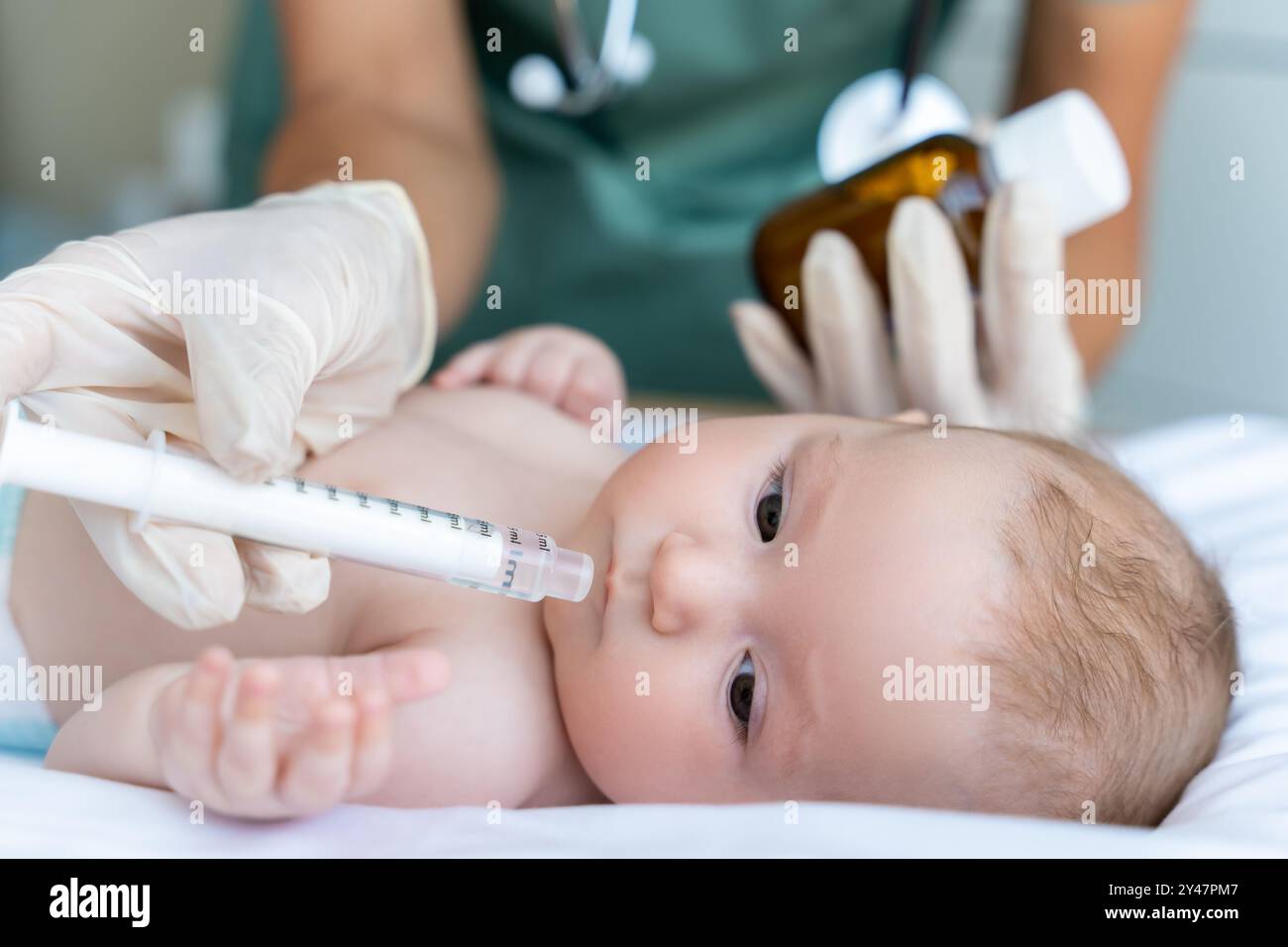 Nurse giving medication to sick kid during a visit to the healthcare ...