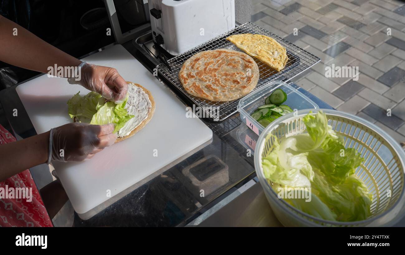The cook prepares a flatbread with filling. Quesadilla Stock Photo - Alamy